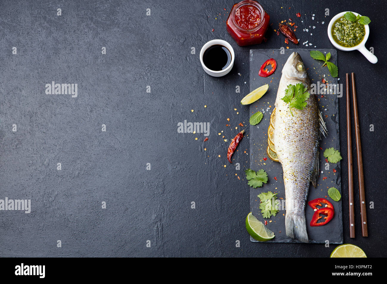 Roasted fish with sauces, fresh herbs and lime Stock Photo - Alamy