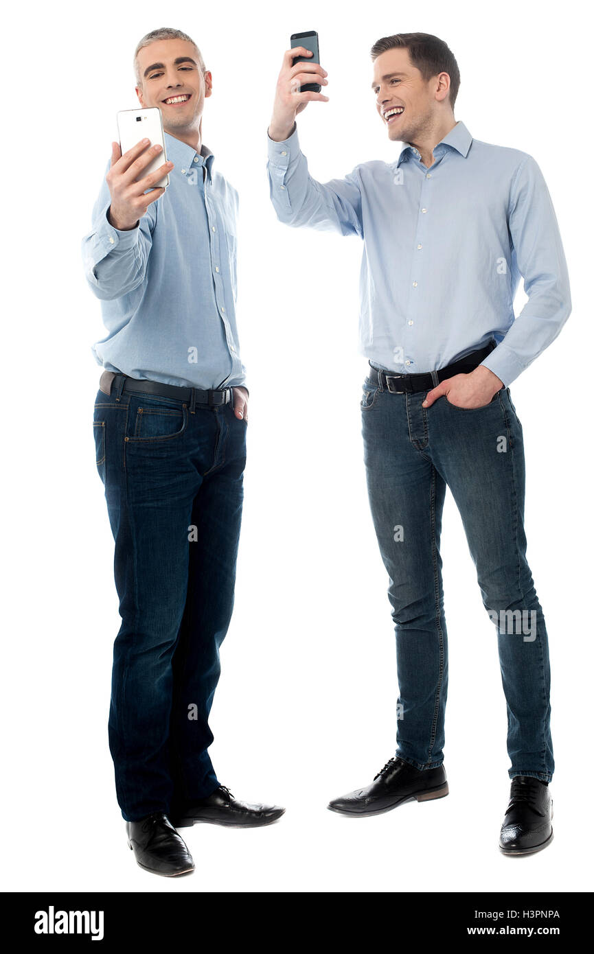 Two young men using their phone Stock Photo - Alamy