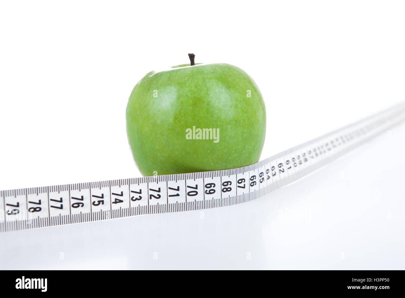 green apple with a ruler Stock Photo - Alamy