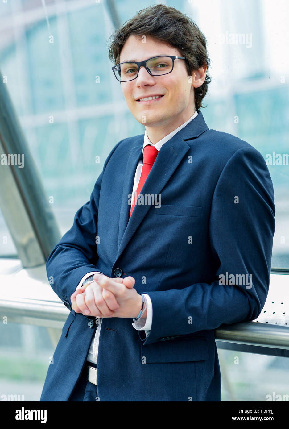 Outdoor portrait of a dynamic junior executive smiling Stock Photo - Alamy