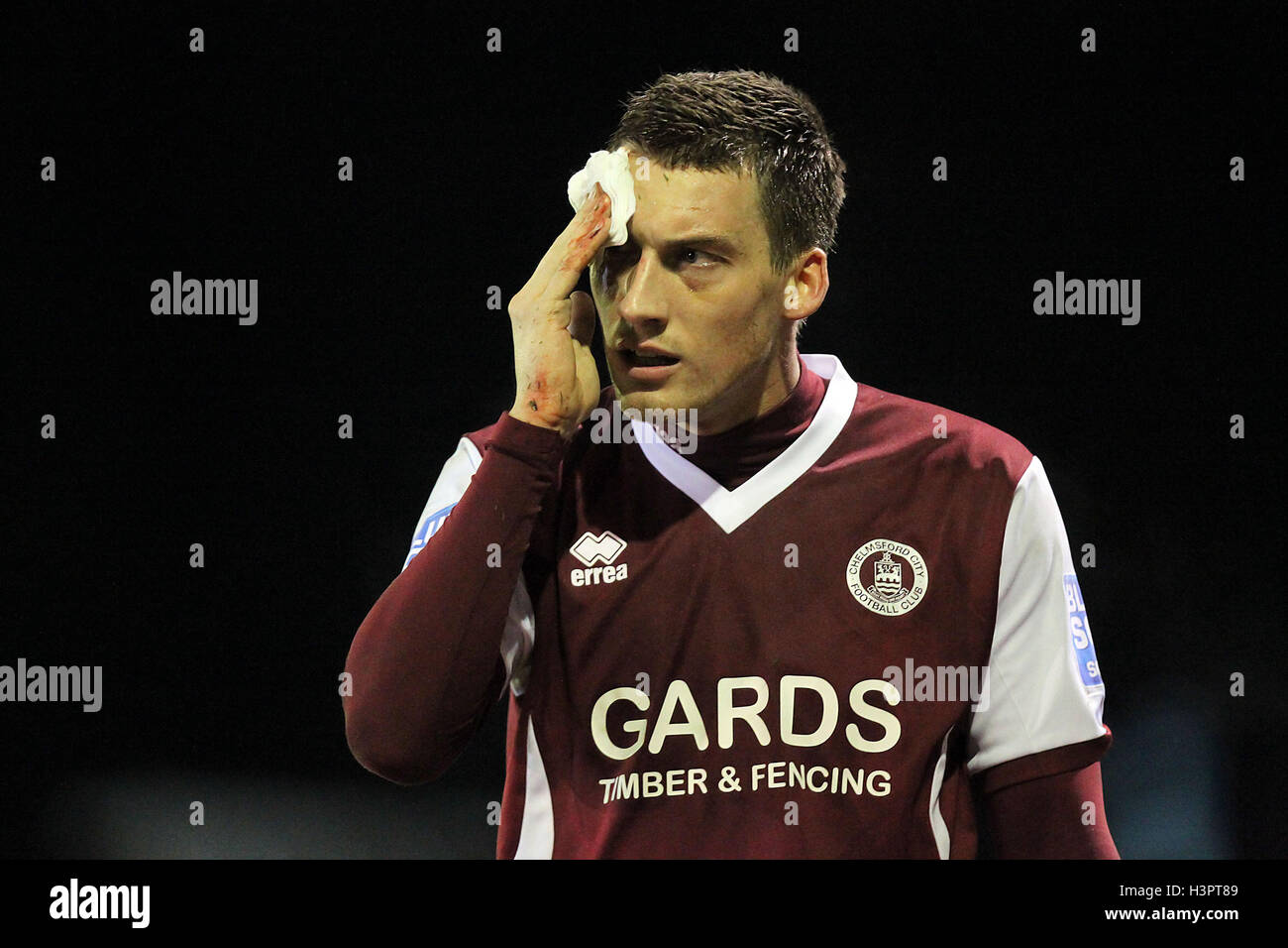 Max Cornhill of Chelmsford leaves the pitch with a cut to his forehead ...