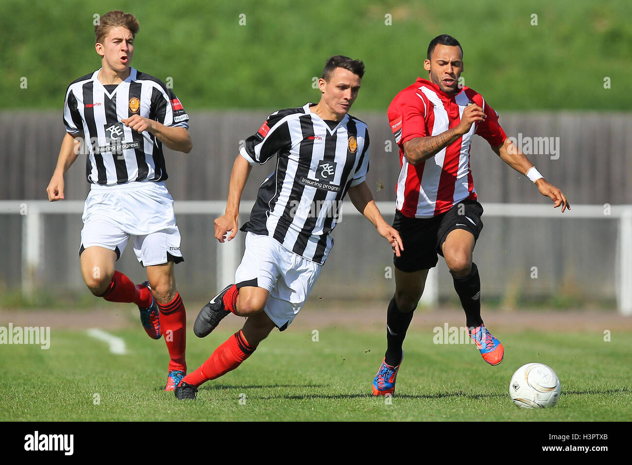 Chris Bourne of AFC Hornchurch (R) seeks to evade Lea Dawson (C) and ...