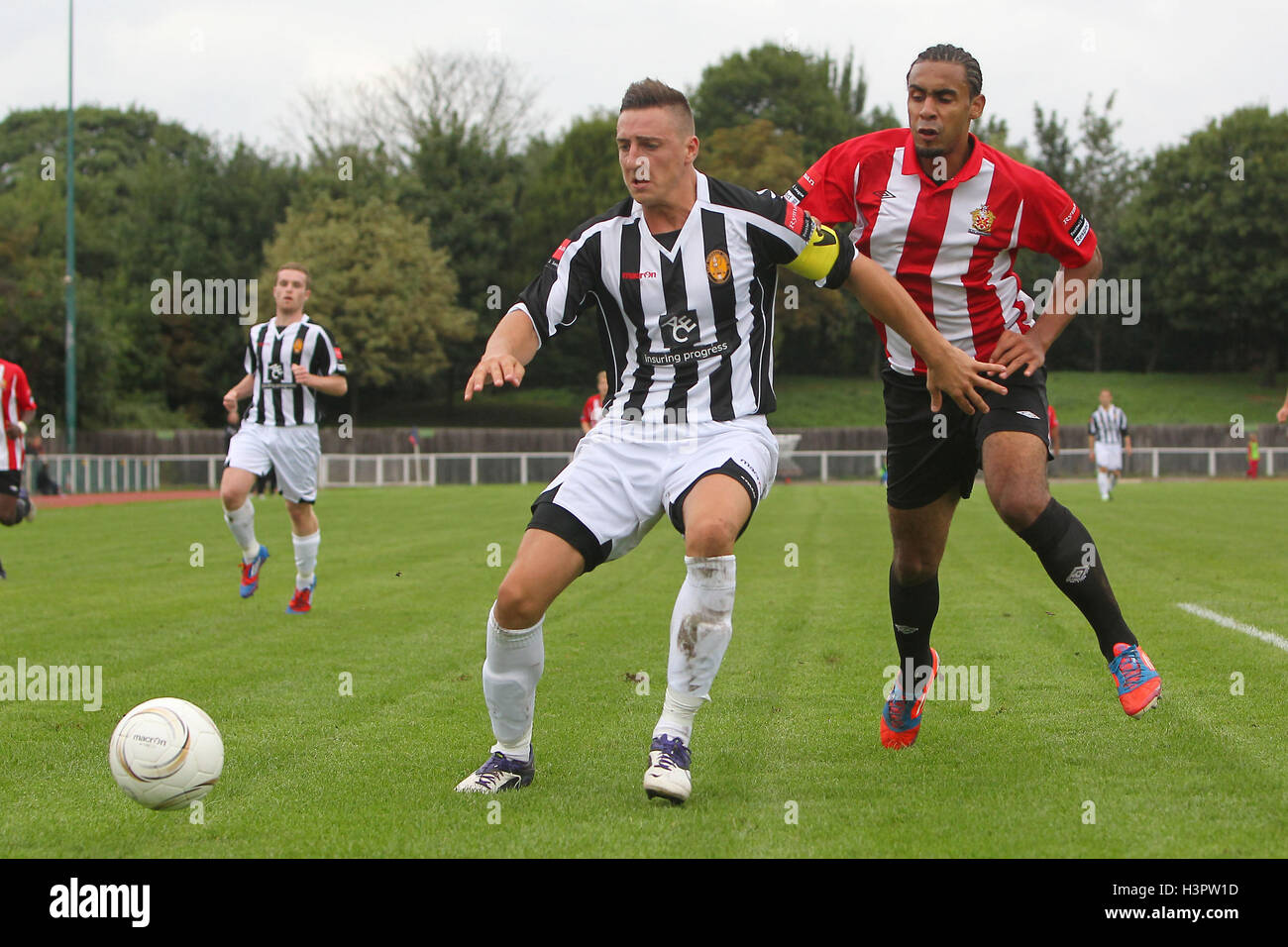Steve Sheehan of East Thurrock shields the ball from Stefan Payne of ...