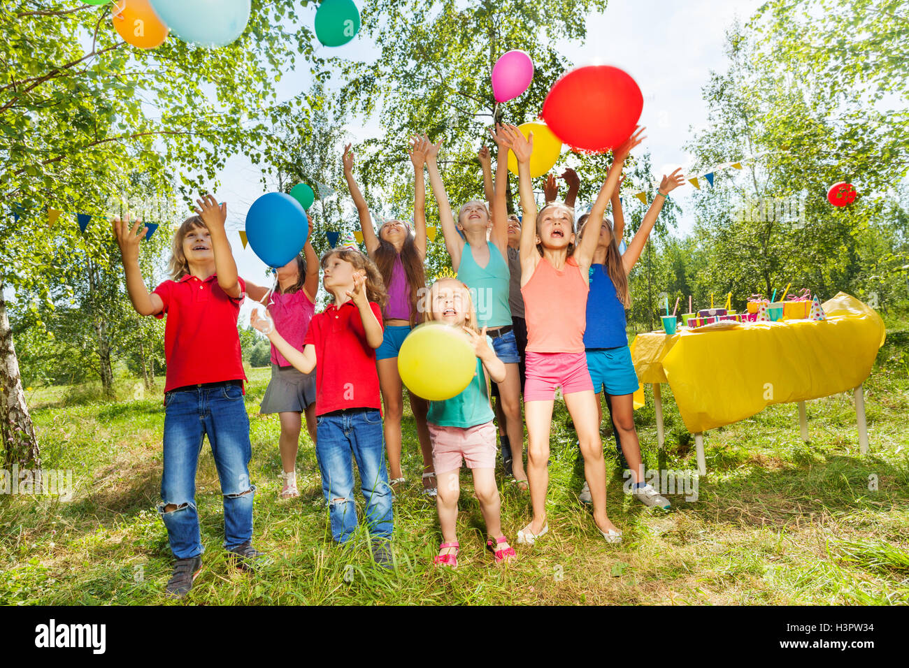 Happy kids playing colorful balloons outside Stock Photo - Alamy