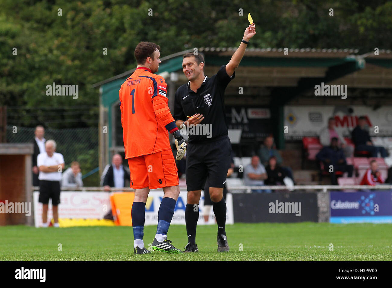Jack Norton of Hampton & Richmond Borough is booked by Referee Peter ...