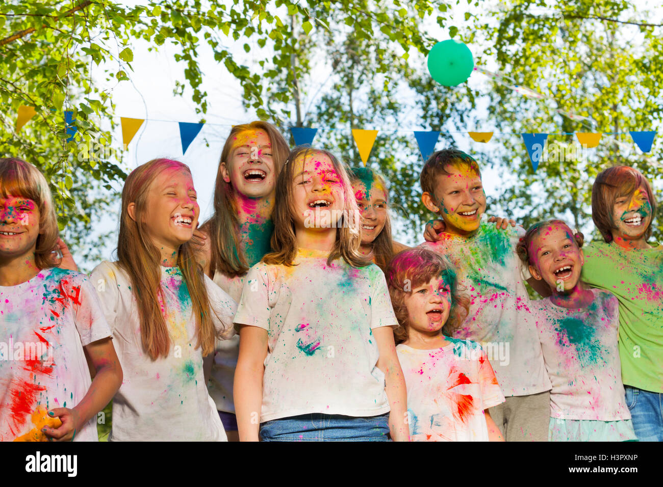 Happy kids painted in the colors of Holi festival Stock Photo - Alamy