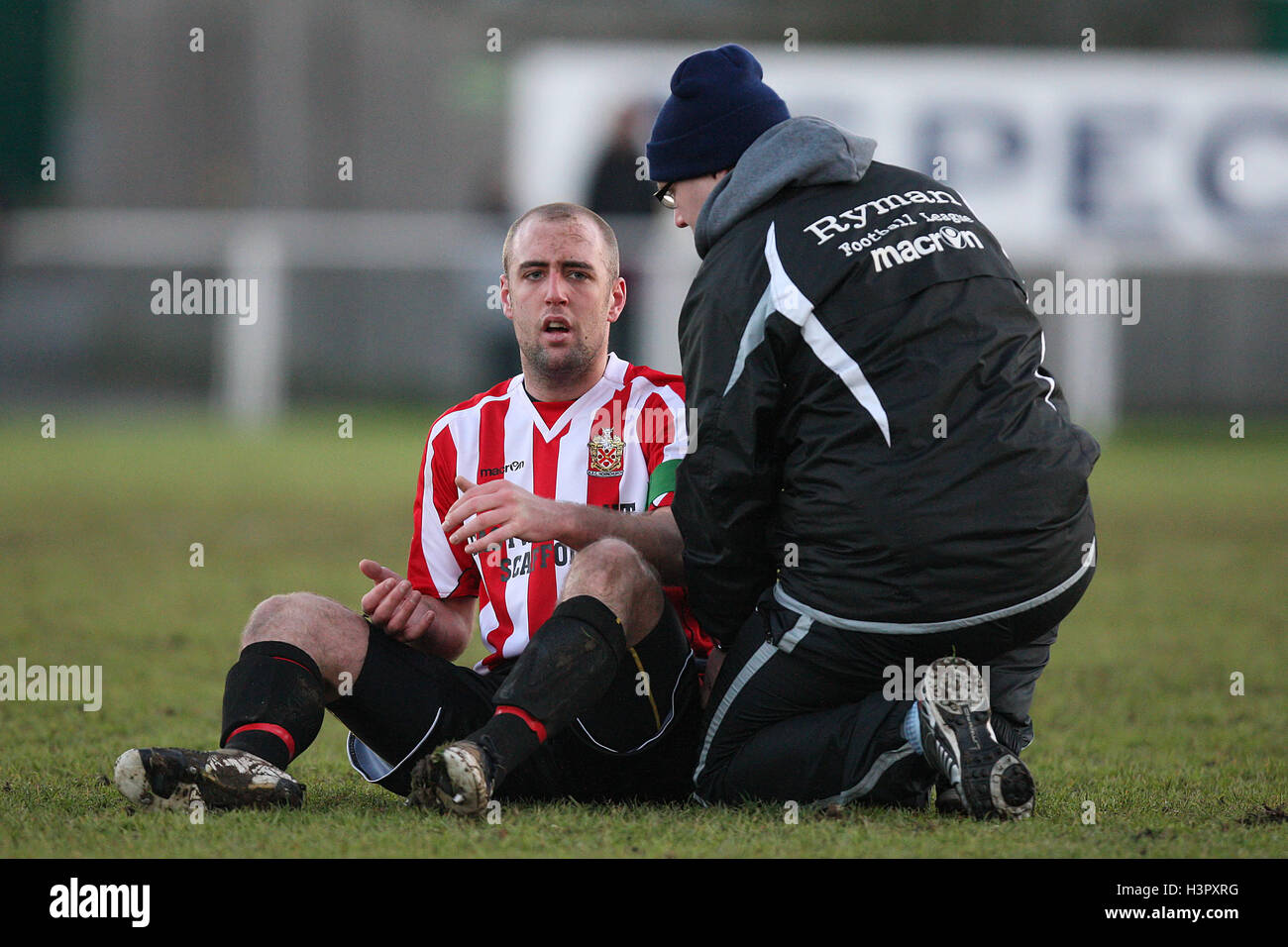 Elliot Styles of Hornchurch is injured by the knee of Lee McGlone of ...