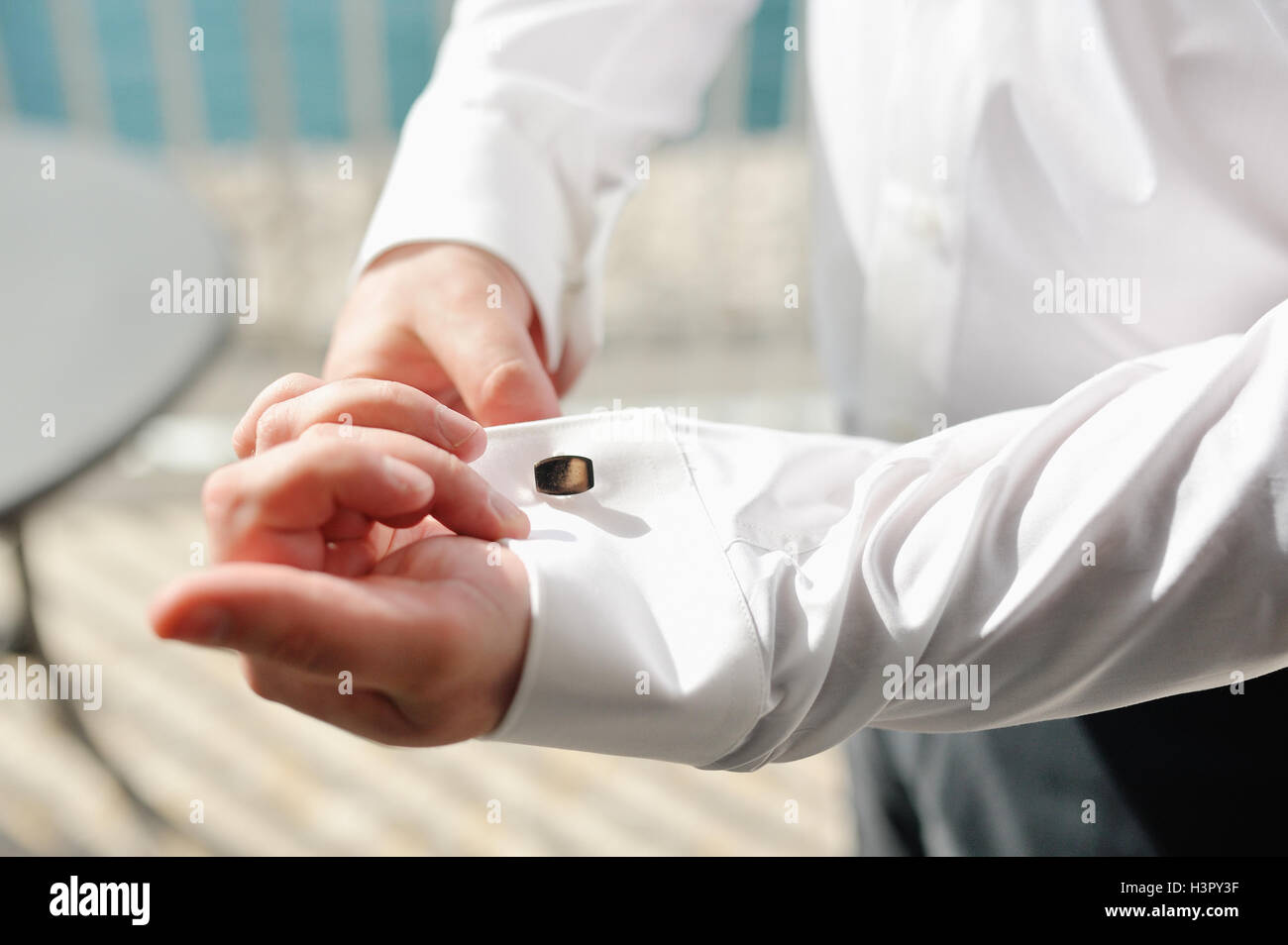 Groom fixing cufflinks of white shirt in wedding day Stock Photo - Alamy