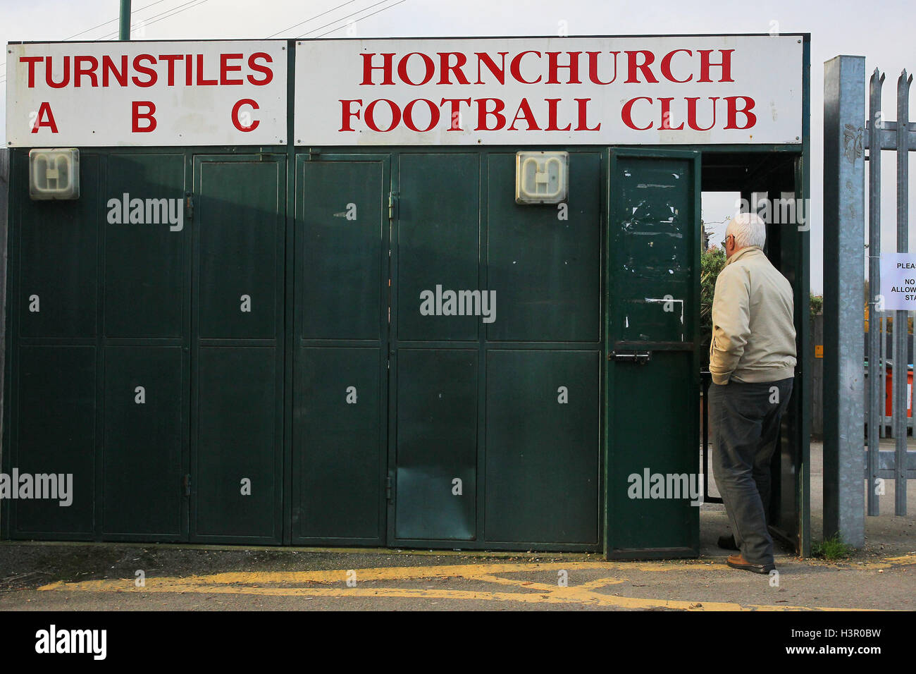 A spectator arrives at the ground and enters through the main turnstile ...