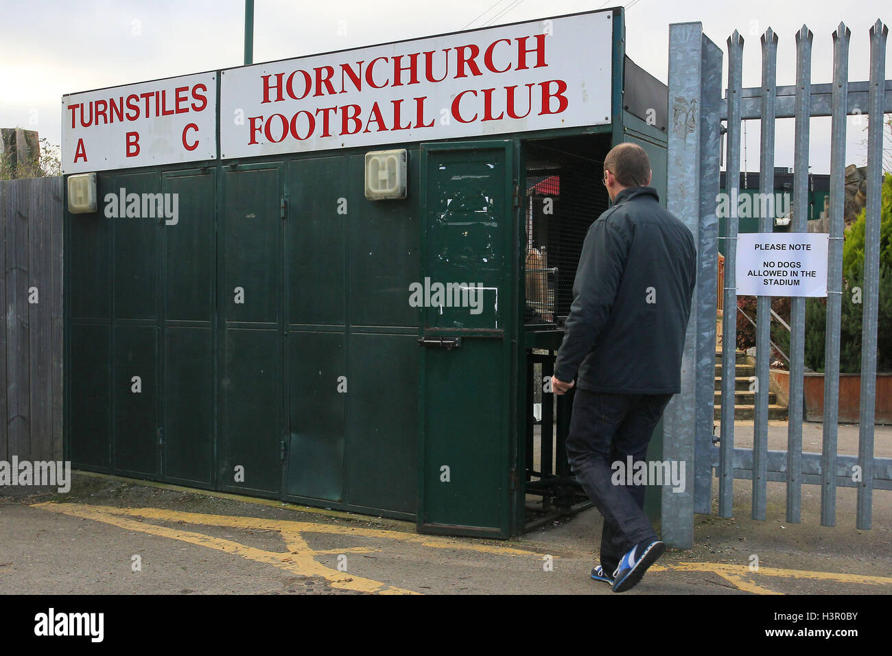 A spectator arrives at the ground and enters through the main turnstile ...