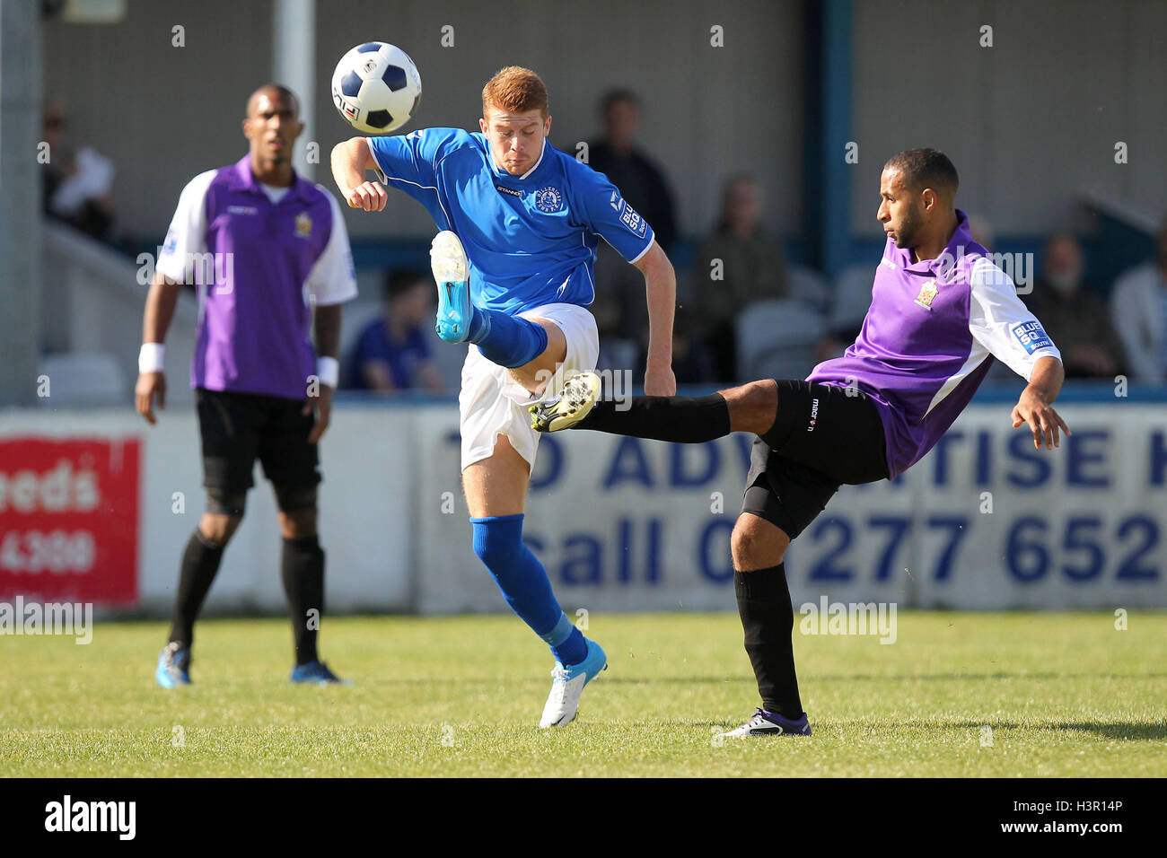 Michael Spencer of Hornchurch clears from Alex Osborn of Billericay ...