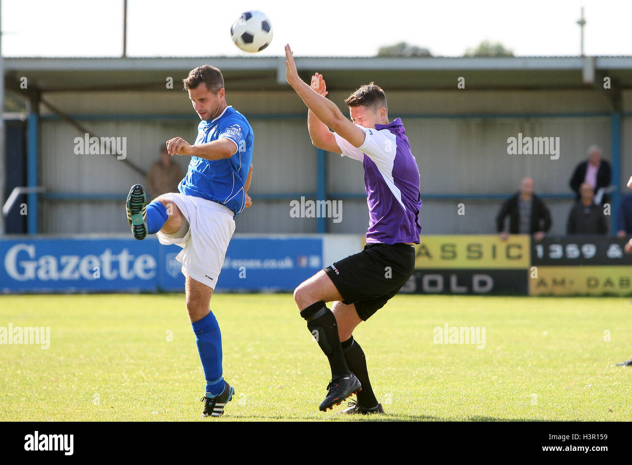Greg Oates of Billericay clears from Frankie Curley of Hornchurch ...