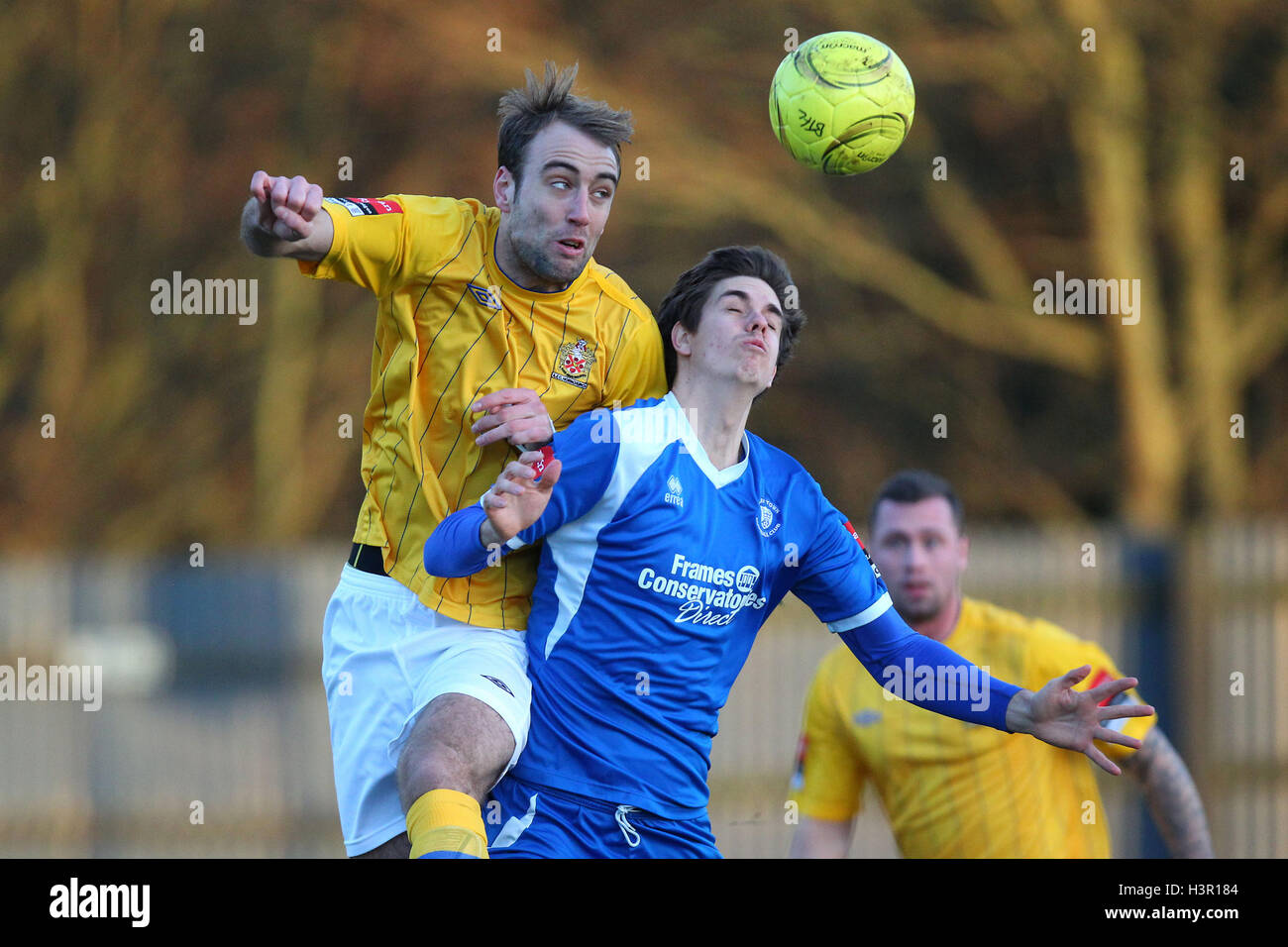 Elliot Styles of AFC Hornchurch rises above Anthony Roulston of Bury ...