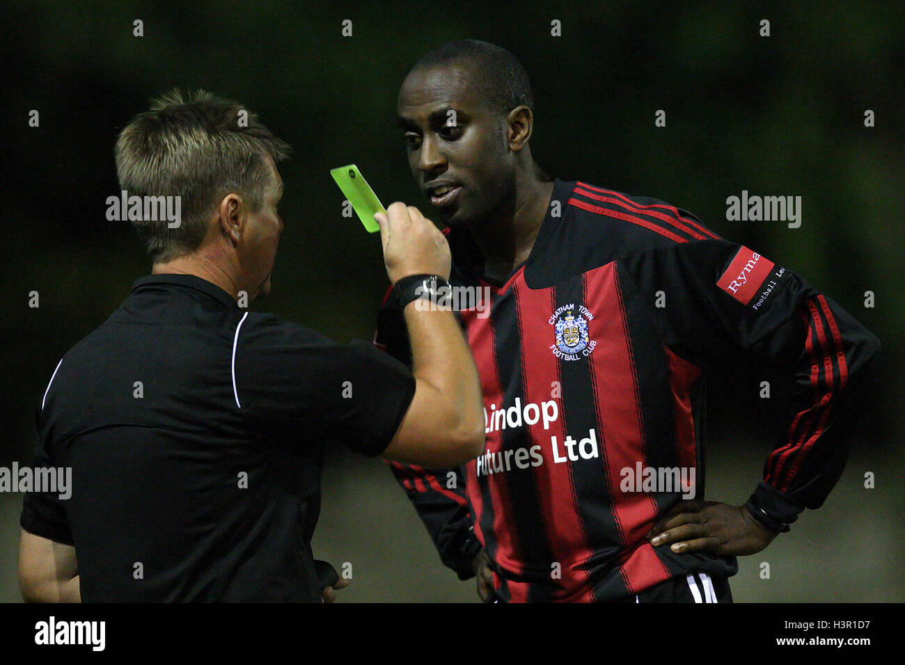 Kes Metitri of Chatham is shown a yellow card by referee David Spain ...