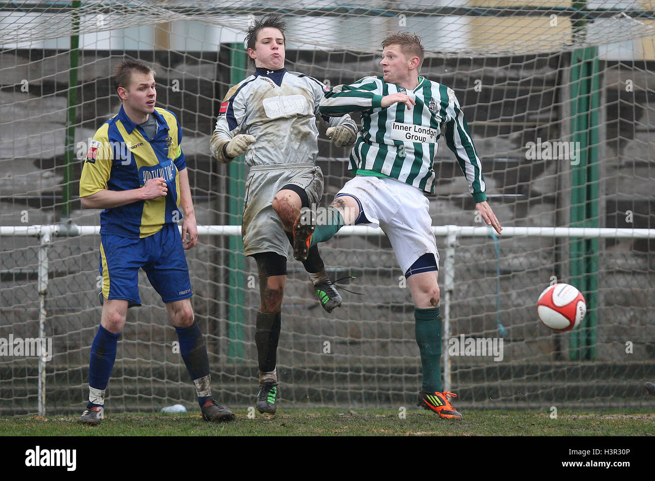 Romford goalkeeper Louis Goodwin-Green clears from Jay Nash of Great ...