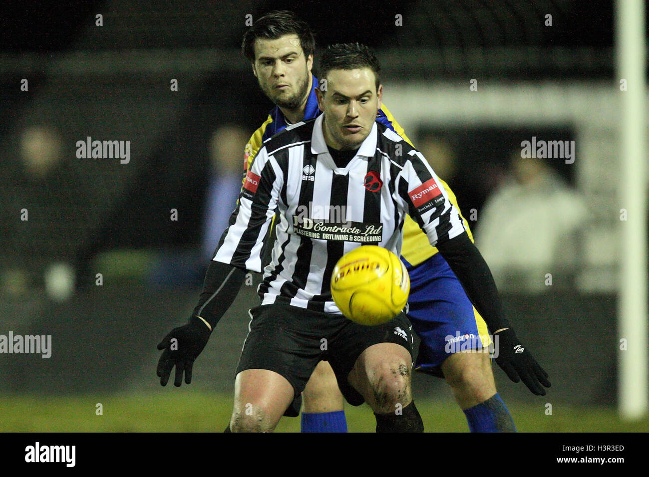 Luke Callander of Heybridge shields the ball from Matt Toms of Romford ...