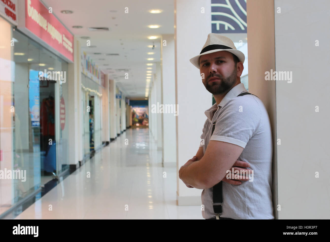 bearded man indoor mall in a hat Stock Photo - Alamy