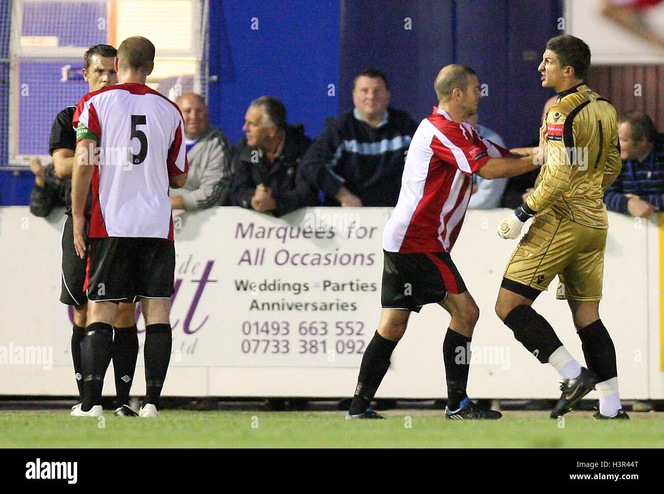 Dave McSweeney (2nd L) restrains Darren Behcet as Elliot Styles (5 ...