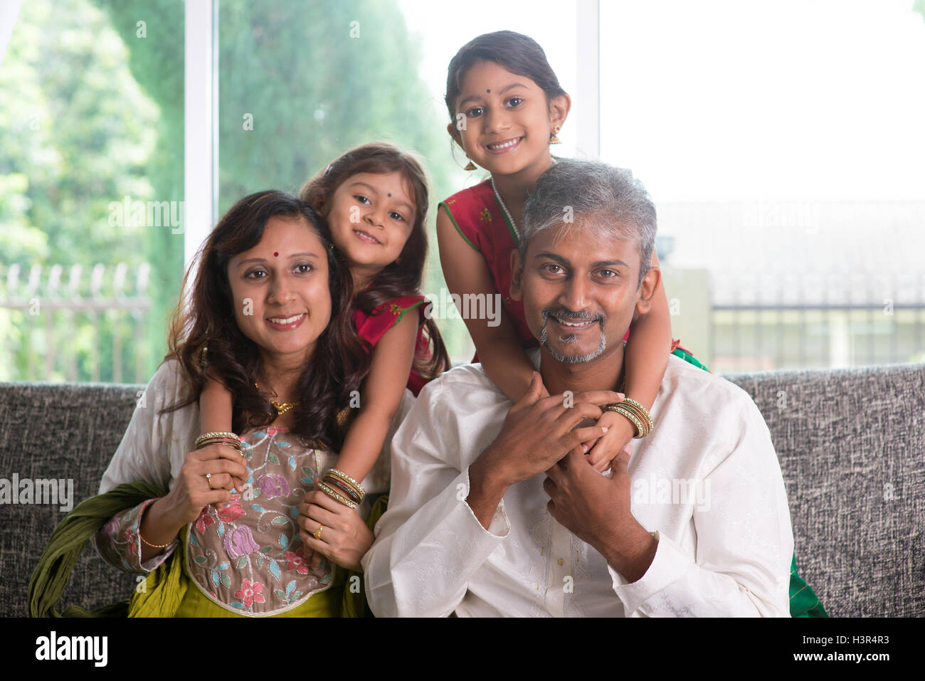 Happy Indian parents and children Stock Photo - Alamy