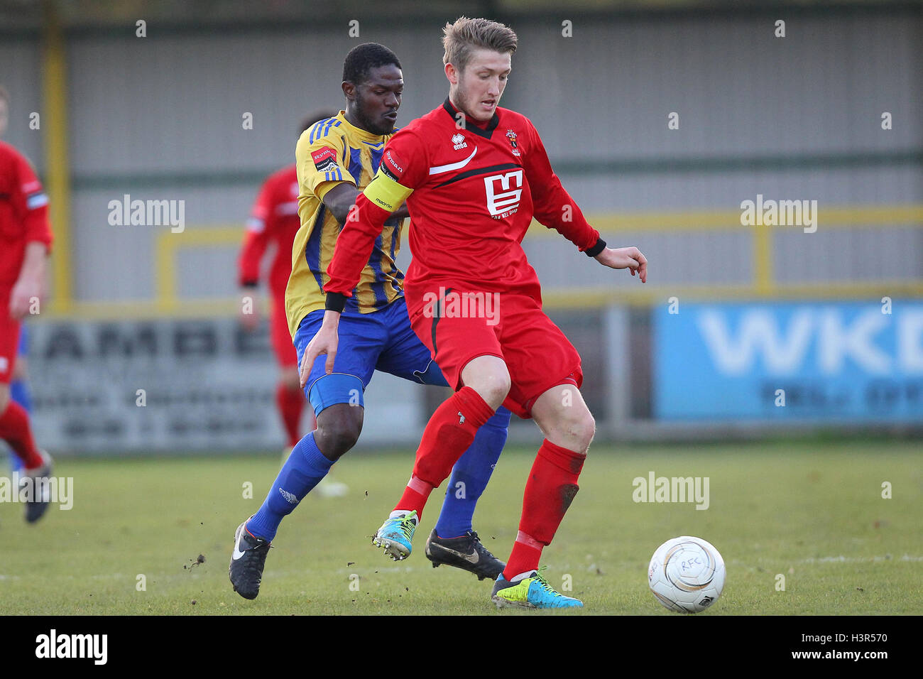 Sam Clarke of Sudbury shields the ball from Abs Seymour of Romford ...