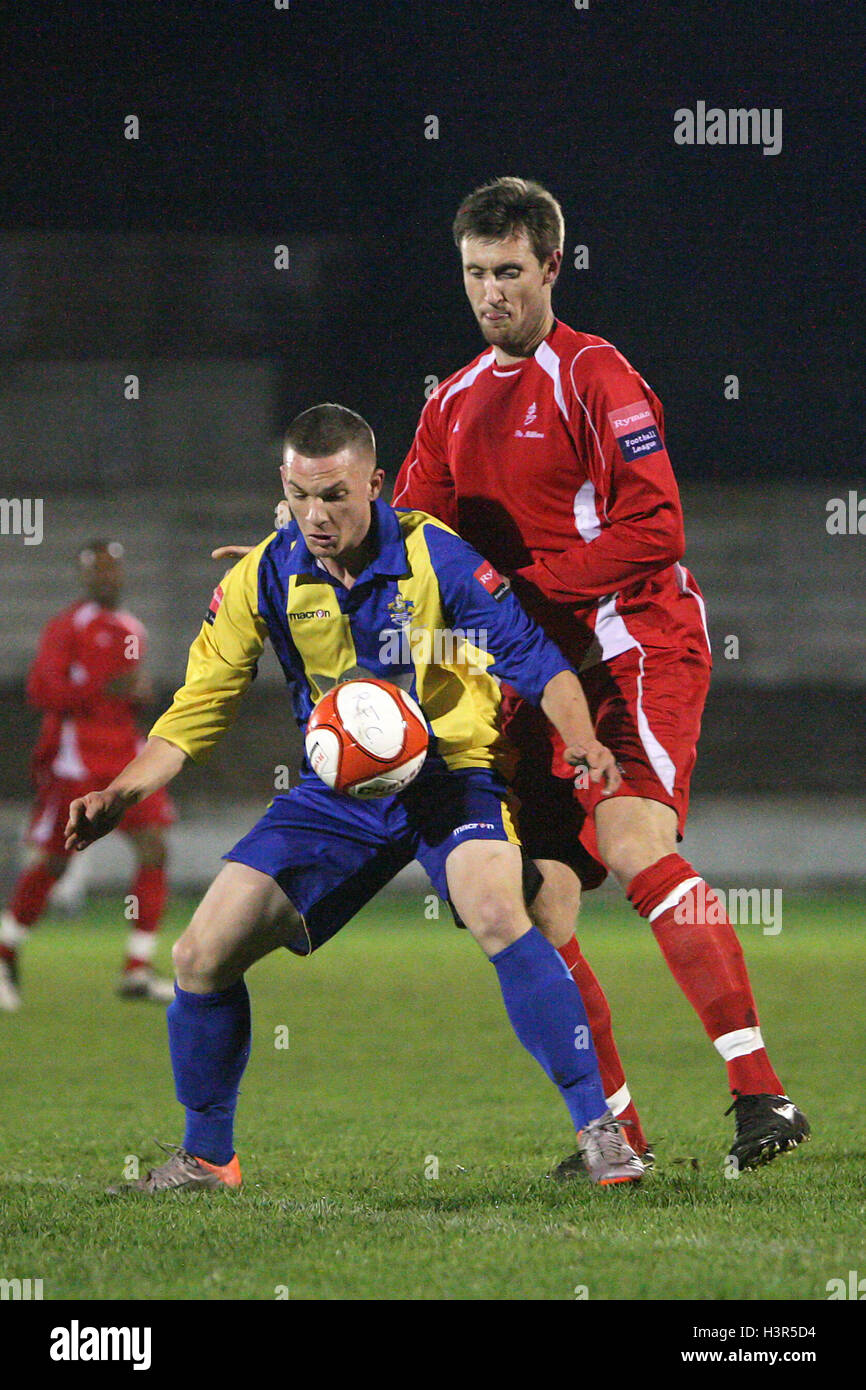 Alex Read of Romford shields the ball from Danny Brown of Aveley ...