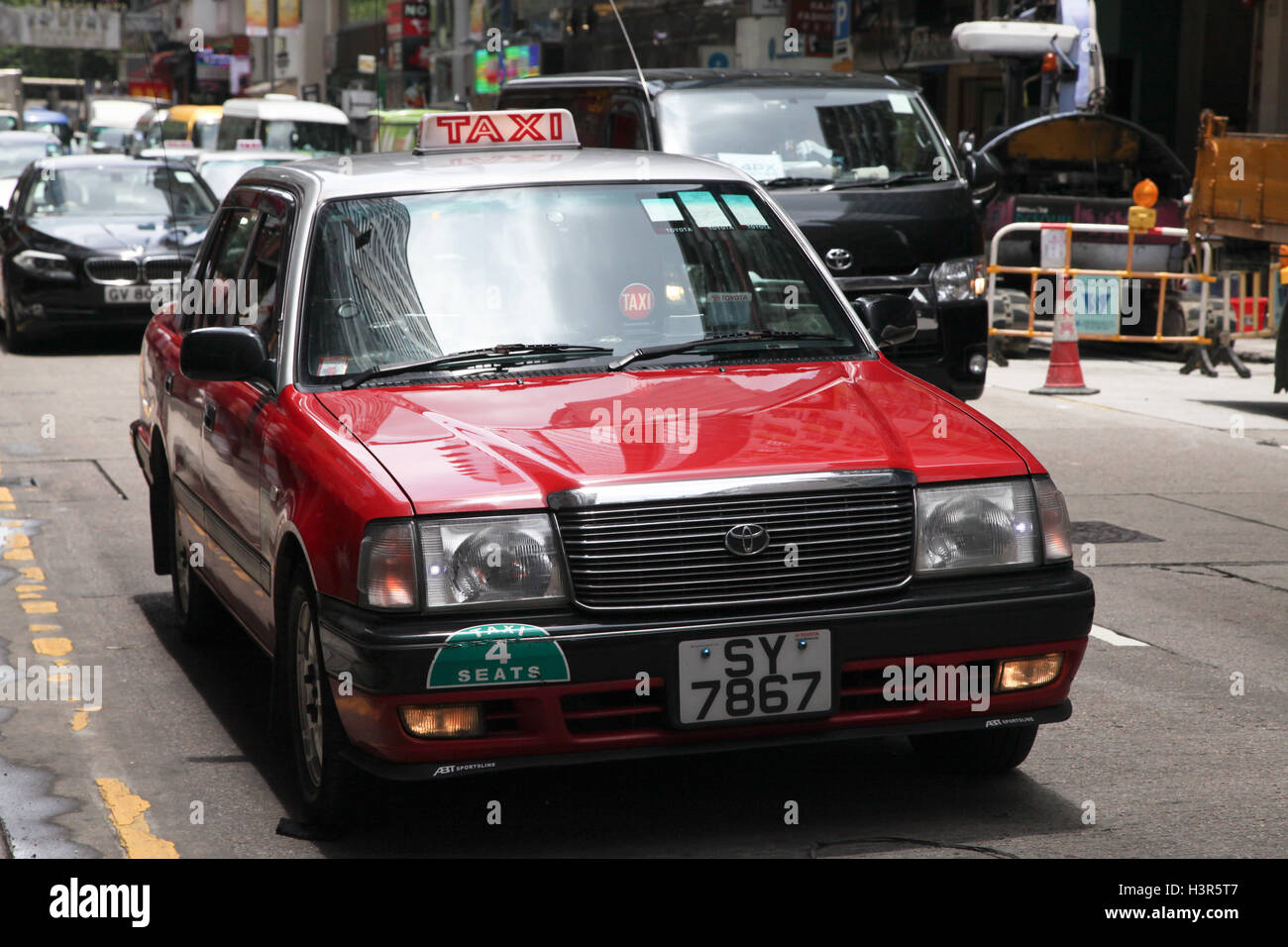 Red and white taxi moving through Hong Kong, China, Asia Stock Photo ...