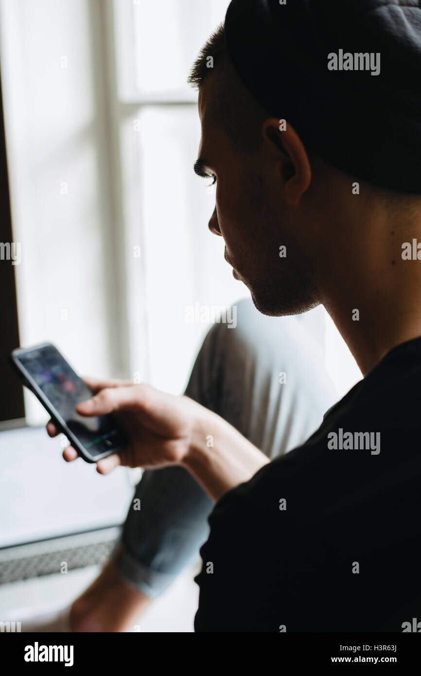 Rear view of man using cellphone Stock Photo - Alamy