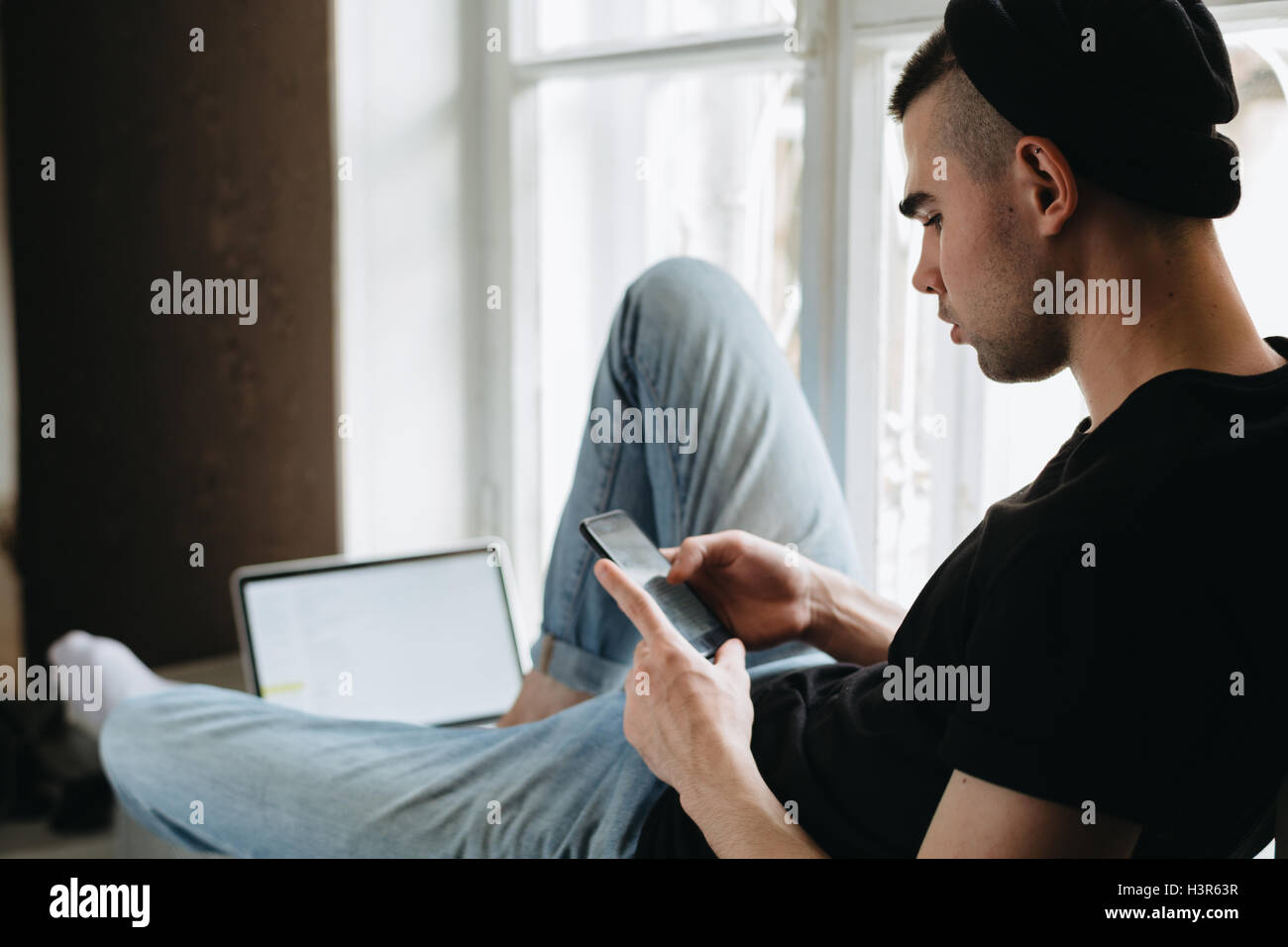 Rear view of man using cellphone Stock Photo - Alamy