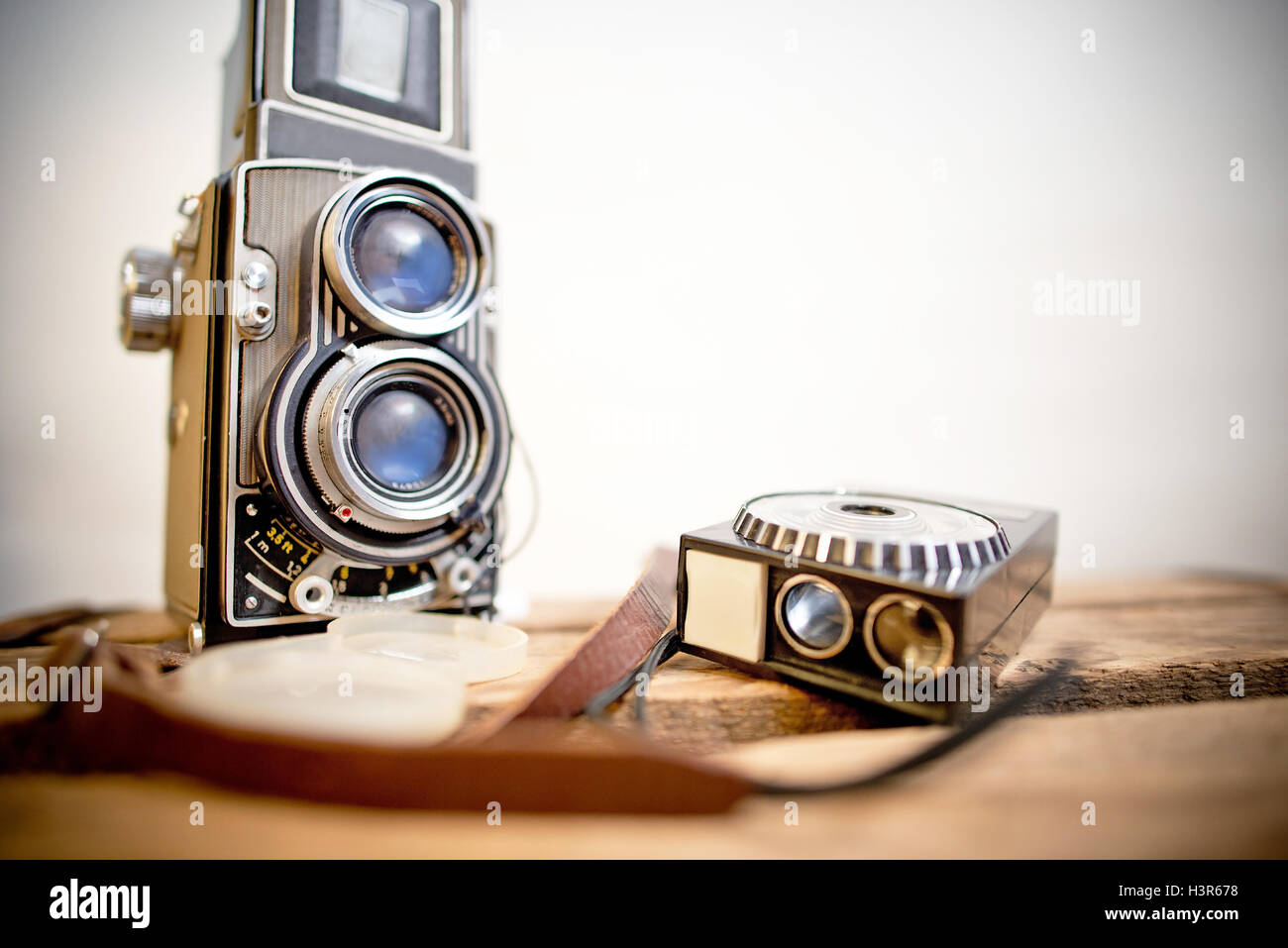 old twin-lens reflex camera with light meter on the white background ...