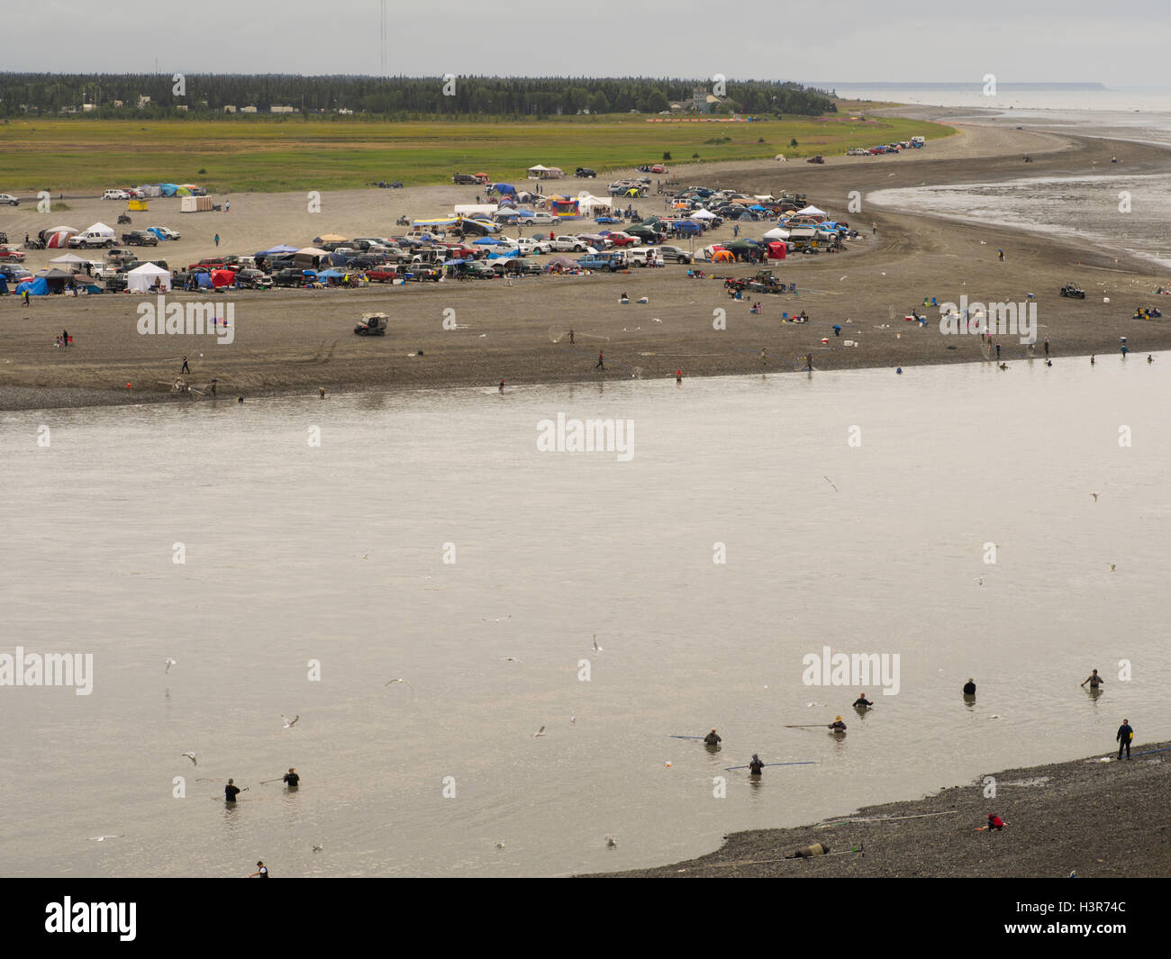 Fishers wade into the mouth of the Kenai River to net salmon. Kenai ...