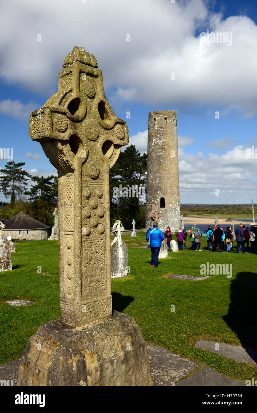 Tourists Stone round tower high cross crosses Clonmacnoise Monastery ...