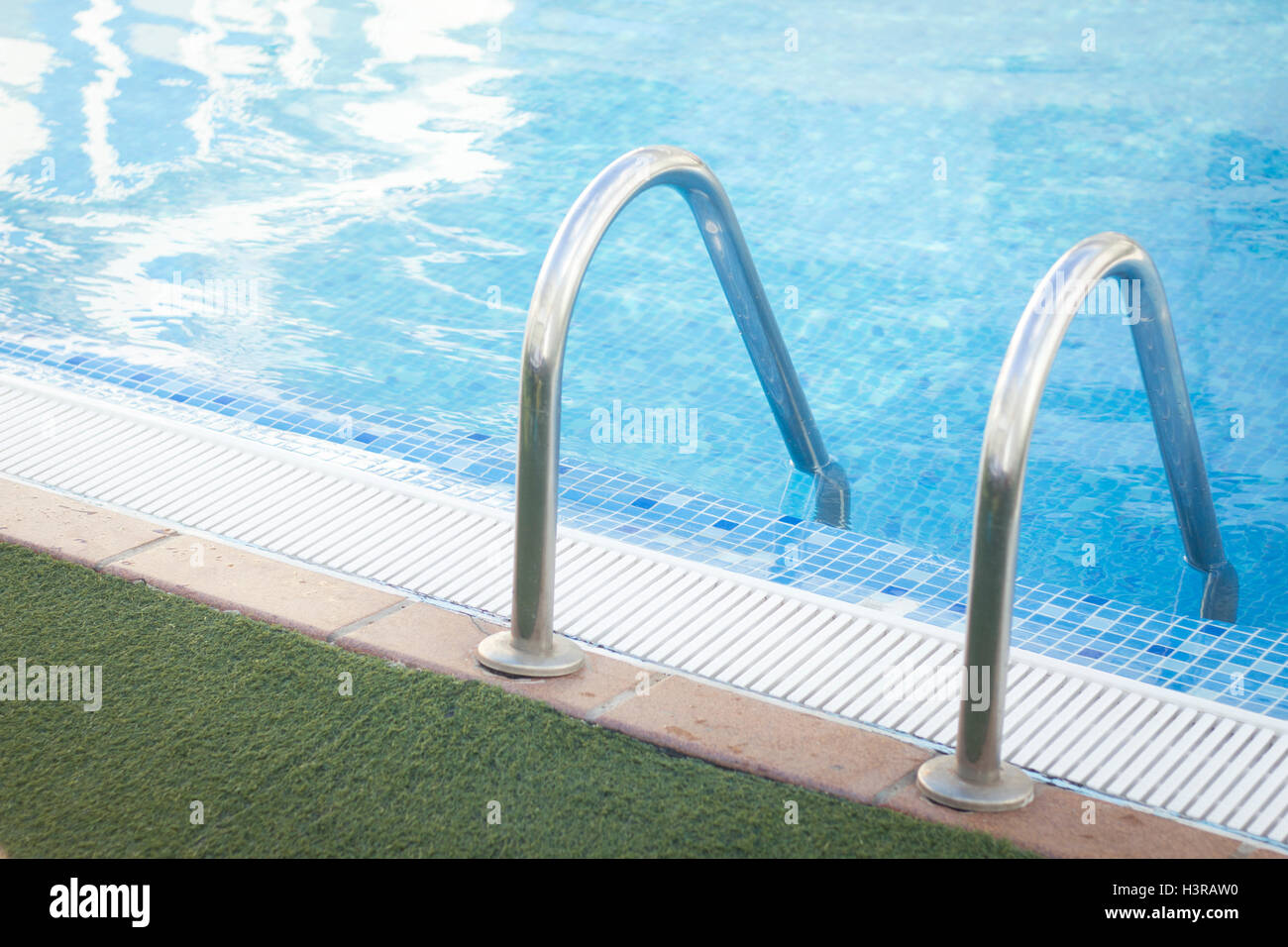 Outdoor swimming pool water on hot summer's day in luxury hotel resort ...