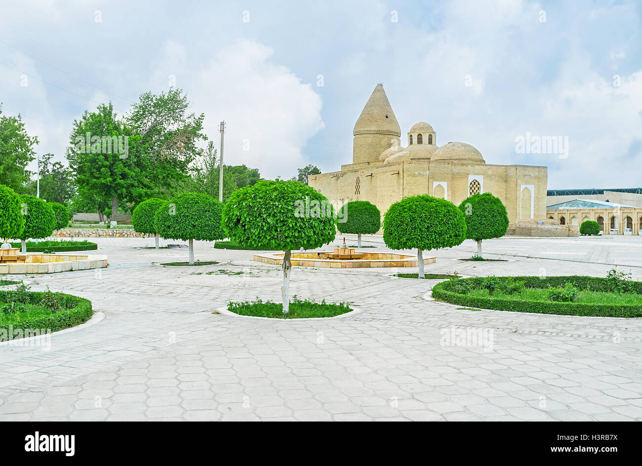 The scenic green park with Chashma-Ayub Mausoleum on the background ...