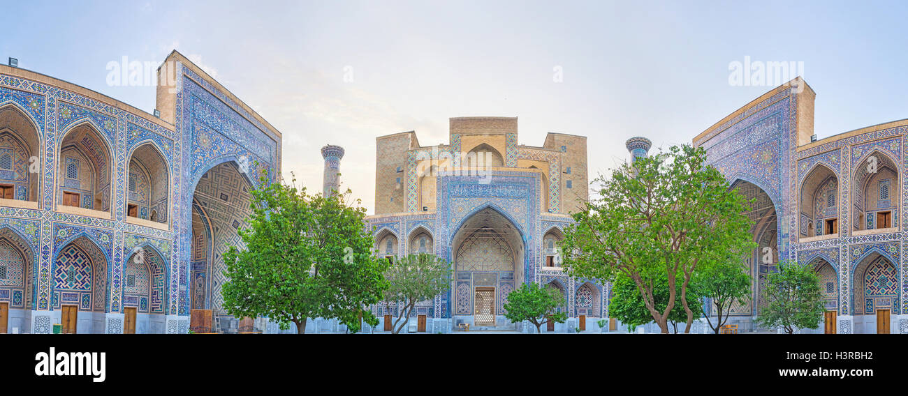 The sun rises behind the bright blue walls of Sher-Dor Madrasah ...