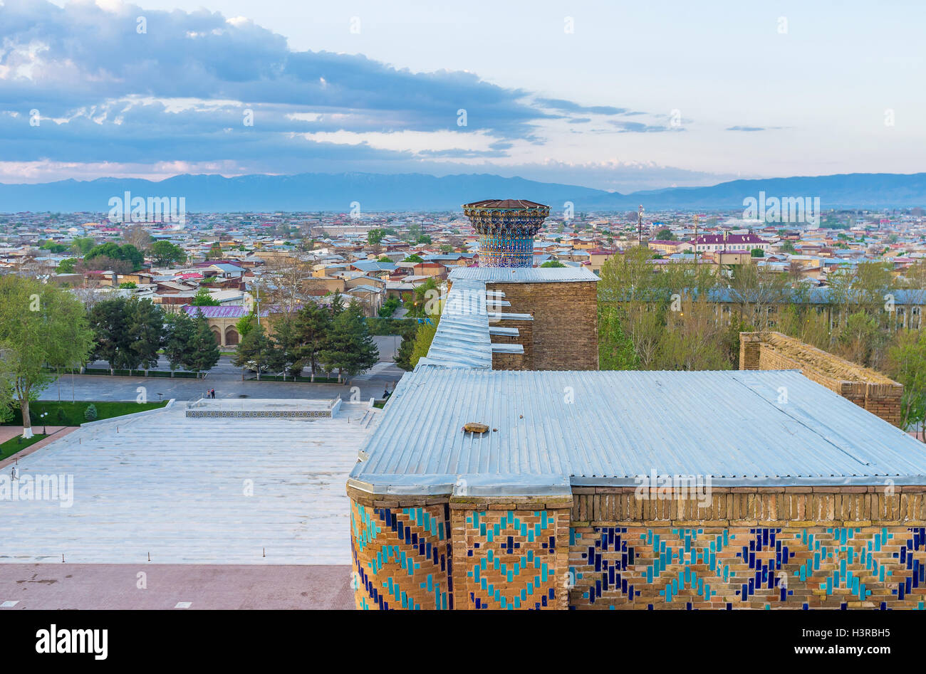 The morning view on the roofs of Samarkand and the foggy mountains on ...