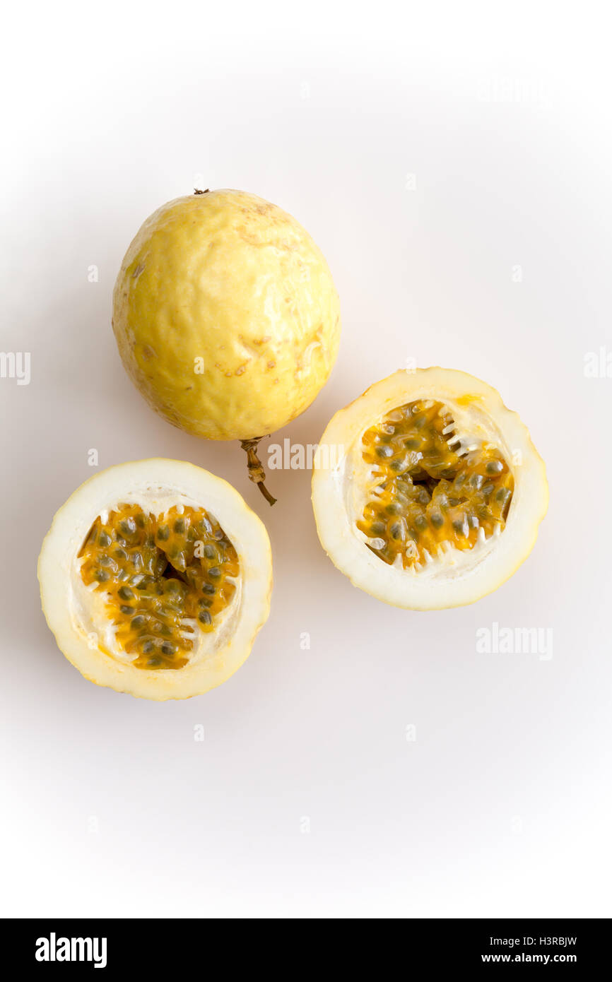 Fresh Brazilian sour passion fruit, whole fruit and split fruit with ...