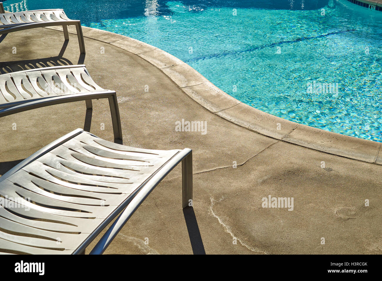 sunbed near swimming pool in tropical resort Stock Photo - Alamy