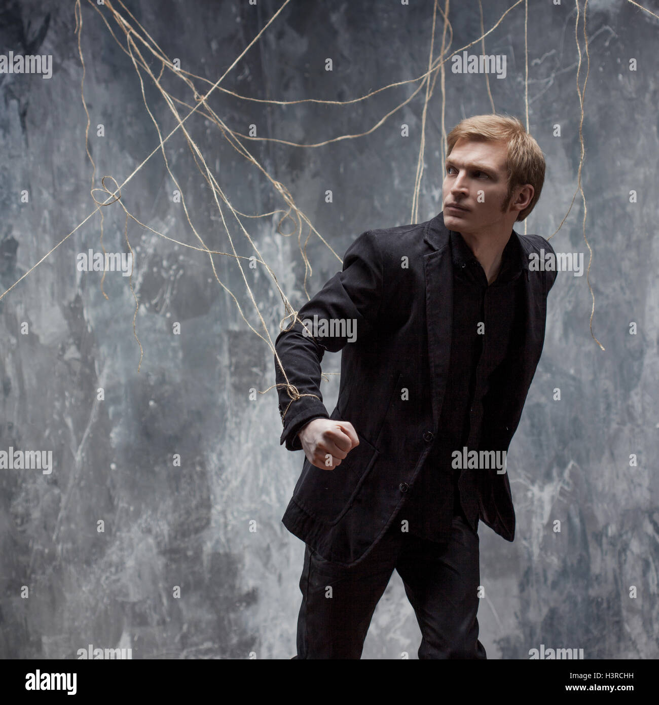 Young man pulling something behind him. Concept of manipulation and ...