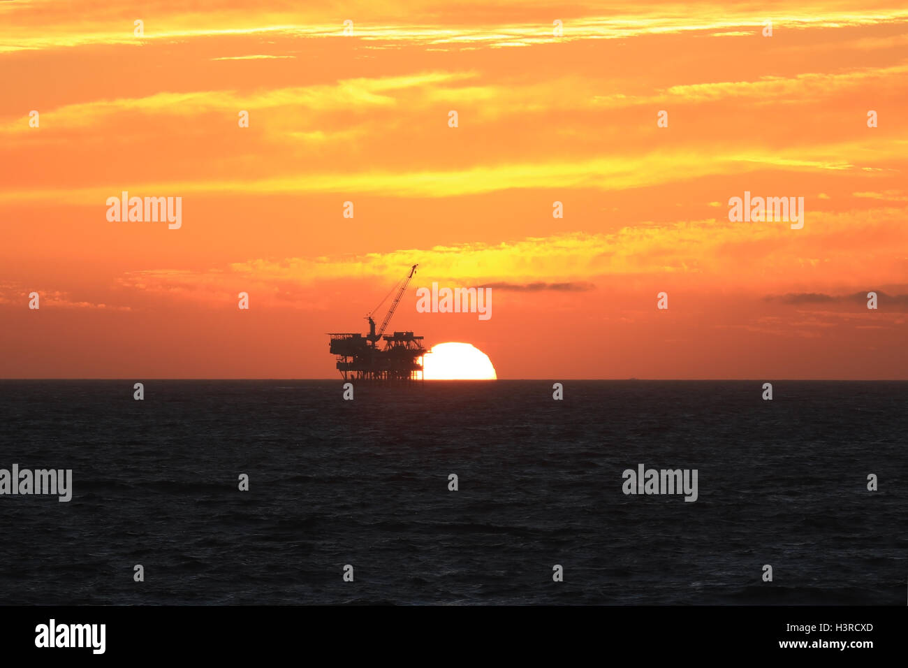 Beach off shore oil rig sunset hi-res stock photography and images - Alamy