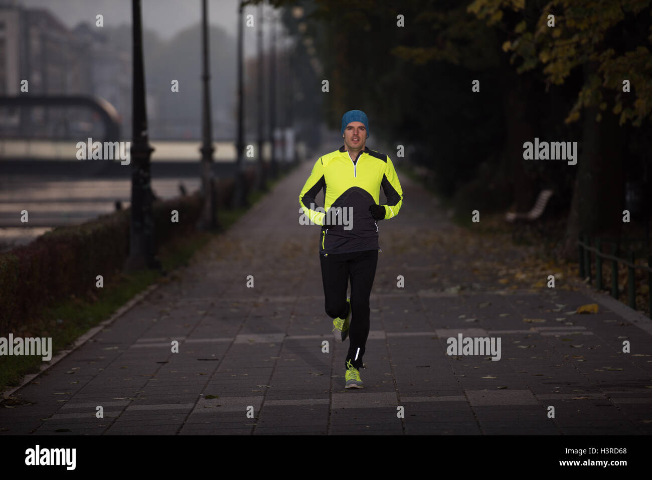 man jogging at cold autumn mornigng Stock Photo - Alamy