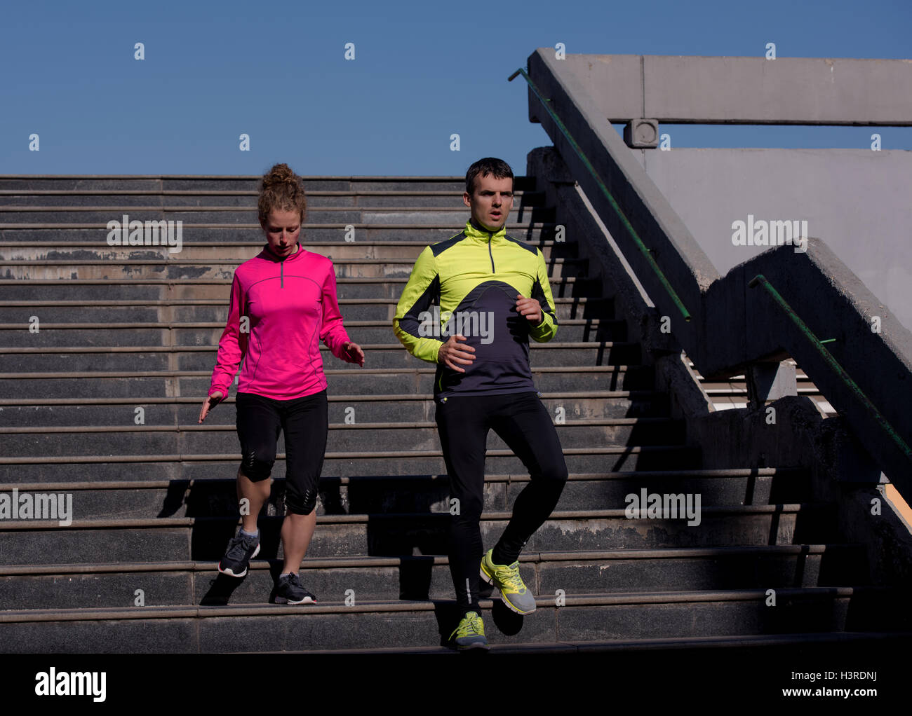 healthy young couple jogging on steps at early morning Stock Photo - Alamy