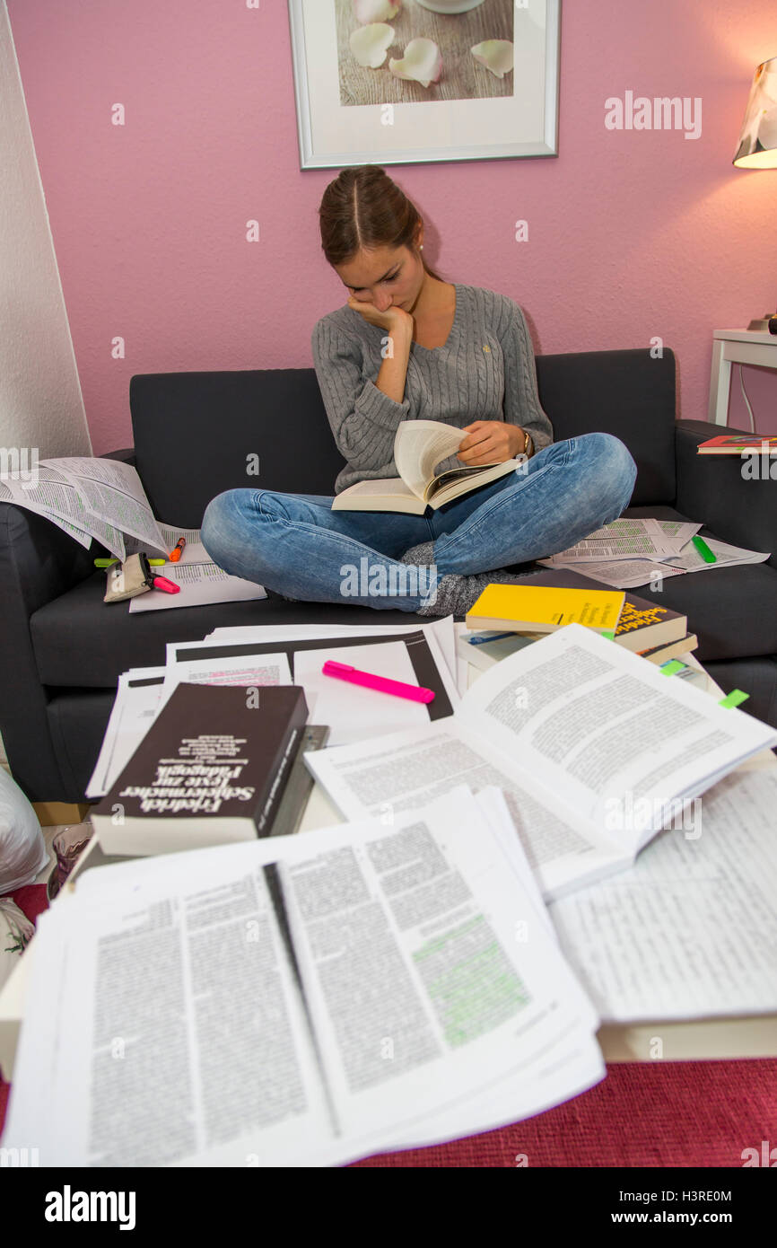 Female student is working in her student apartment, for a examination ...