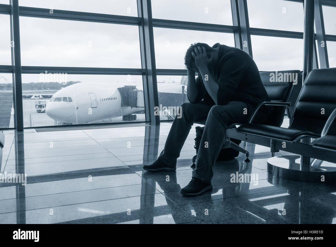 Tired man waiting delayed flight hi-res stock photography and images ...