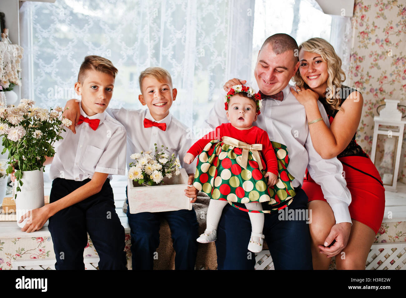 Caucasian family posed in vintage studio room Stock Photo - Alamy
