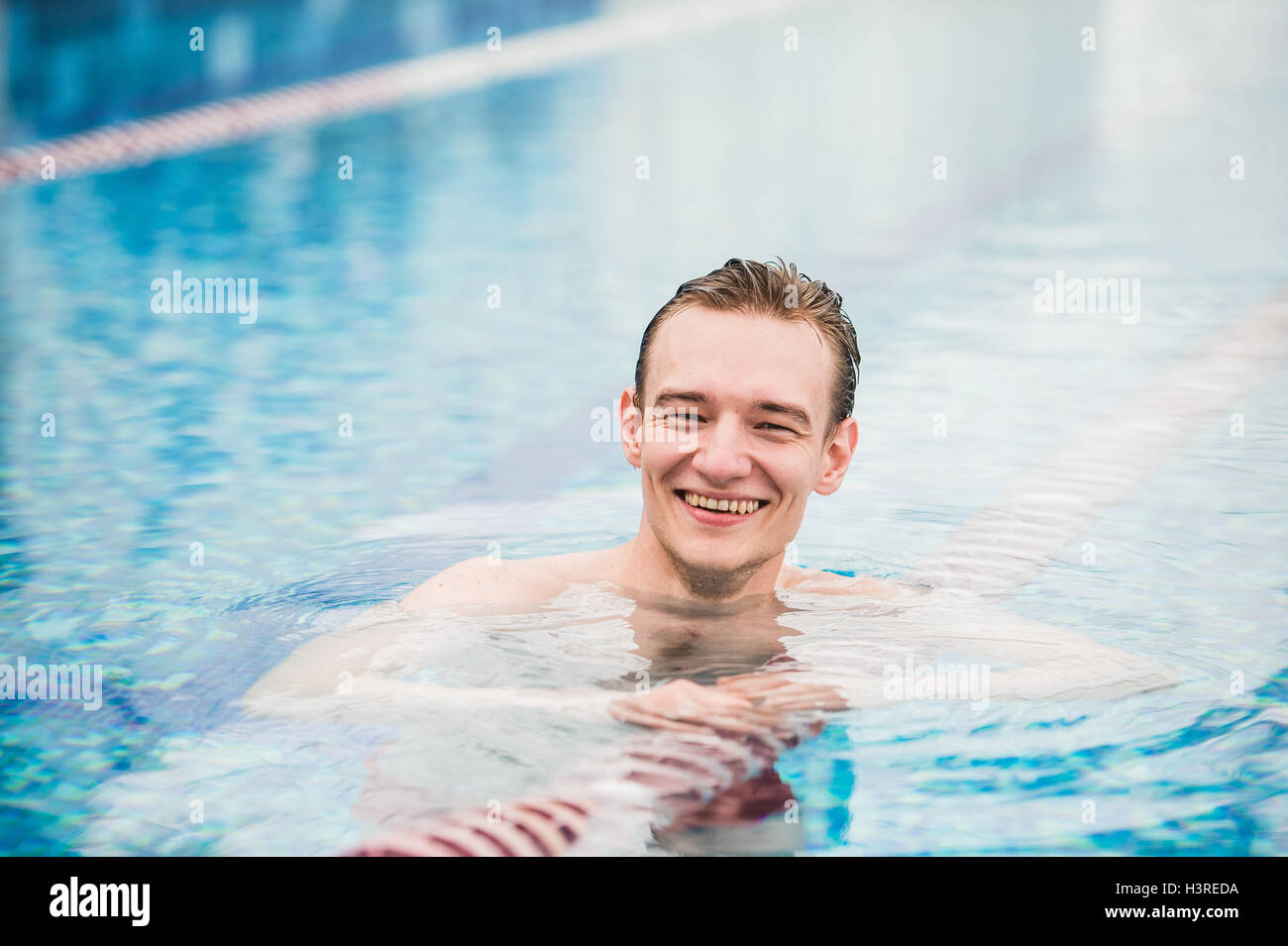 Handsome athletic male posing in a swinning pool Stock Photo - Alamy
