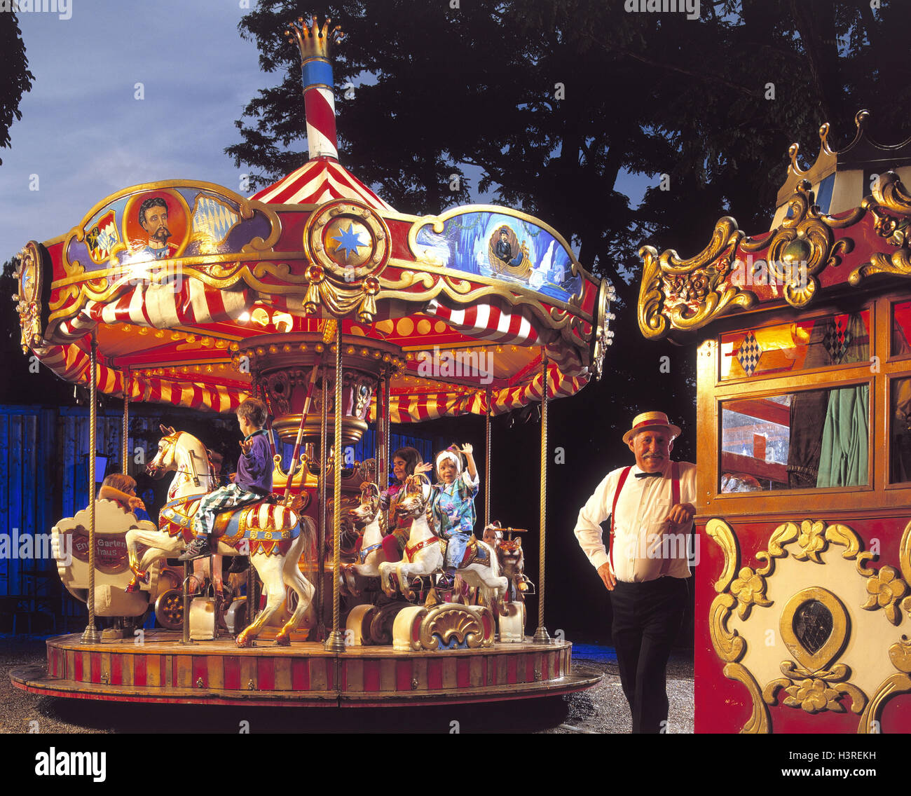 Roundabout, man, cash box, evening mood, outside, carousel, children ...