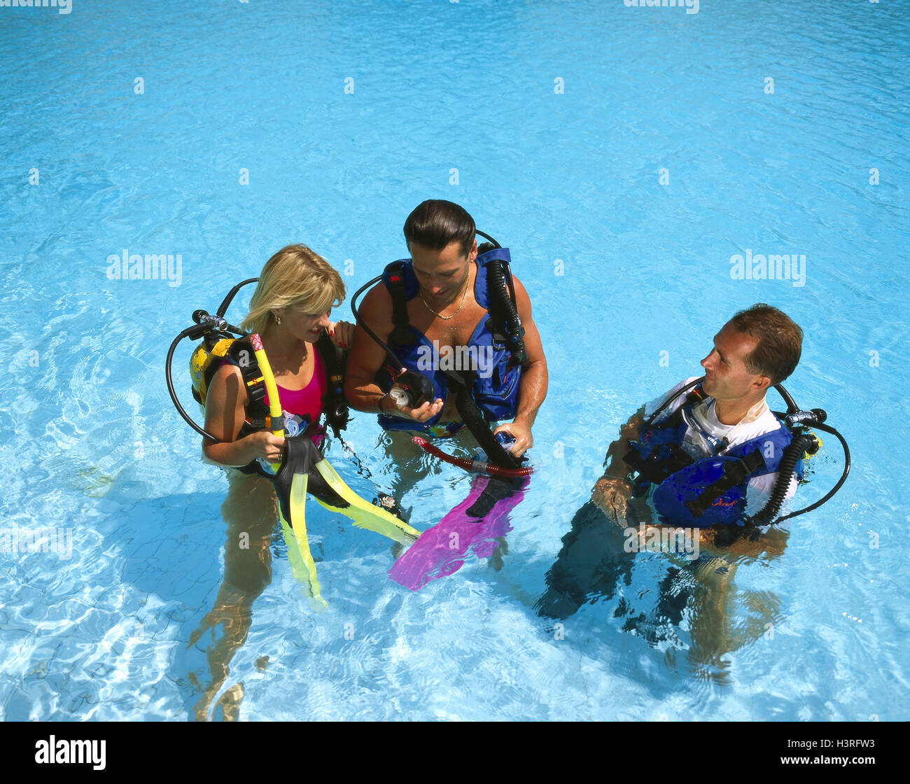 three divers in the shallow water Stock Photo - Alamy