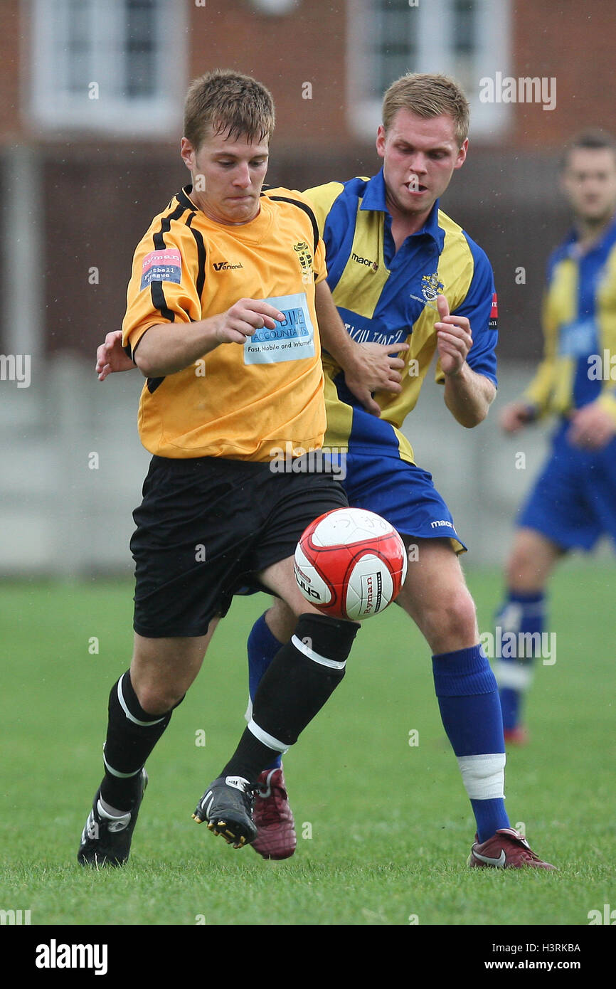 Sam Ruff of Cheshunt shields the ball from Jack Barry of Romford ...