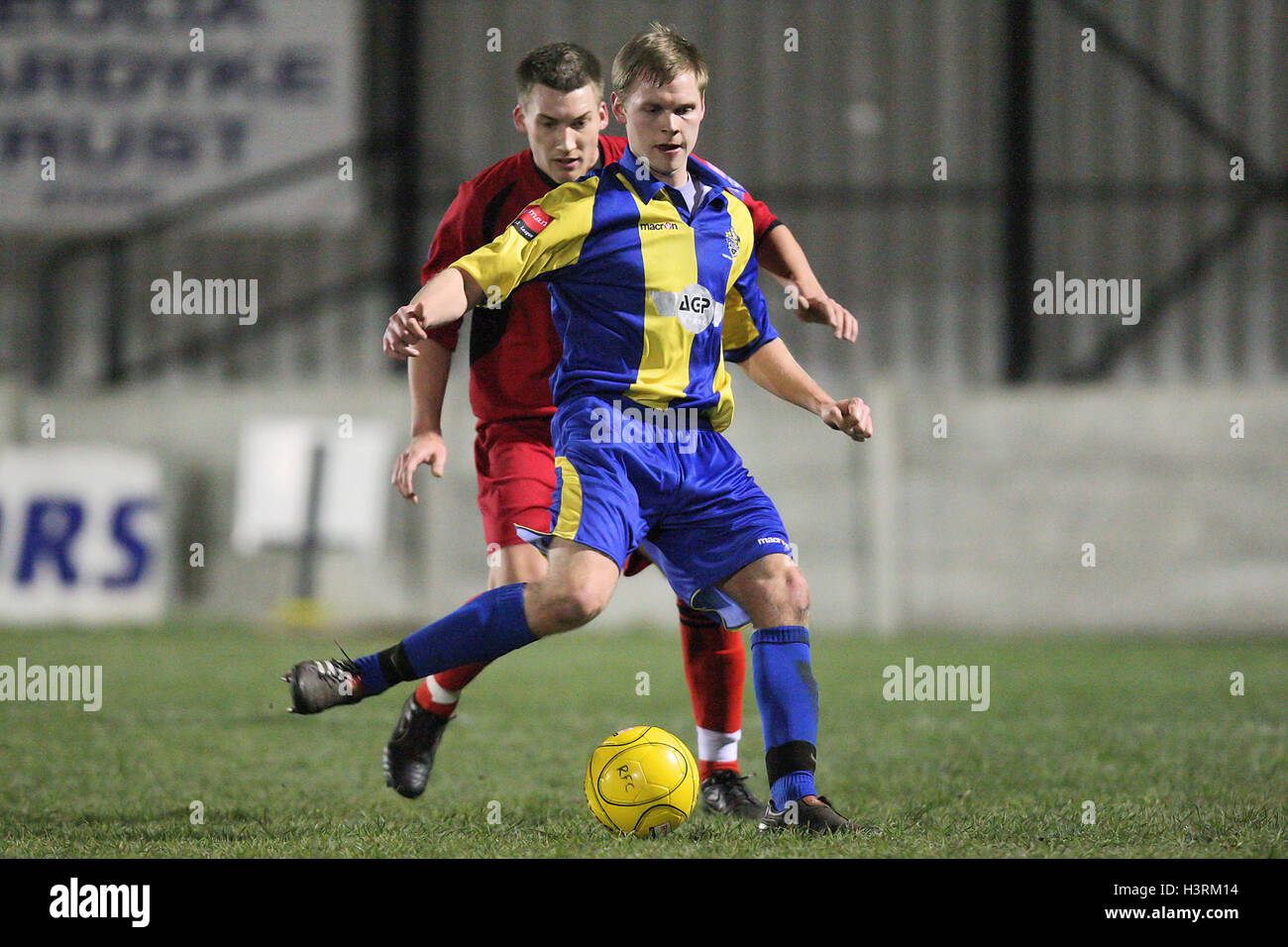 Jack Barry of Romford shields the ball from Max Cornhill of East ...