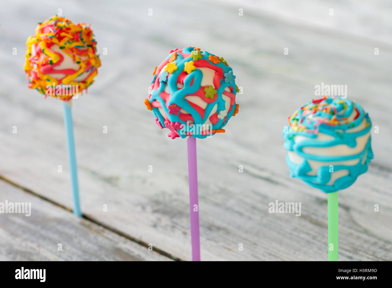 Three candies on sticks Stock Photo - Alamy